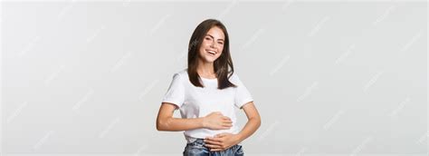 Free Photo Satisfied Smiling Brunette Girl Rubbing Belly After Eating