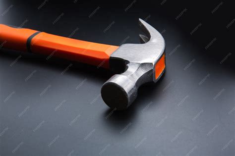 Premium Photo Orange Hammer On Dark Matt Background Closeup
