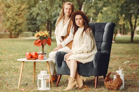 Free Photo Elegant And Stylish Girls Sitting On A Chair In A Park