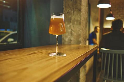 Premium Photo Elegant Glass Of Craft Beer And Taps Beer Taps In A Row