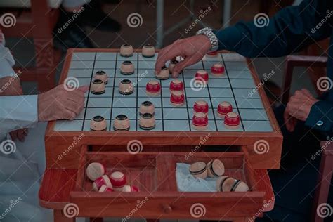 traditional qatari men playing dama board game in katara beach doha