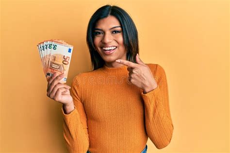 Young Latin Transsexual Transgender Woman Holding Bunch Of 50 Euro Banknotes Smiling Happy
