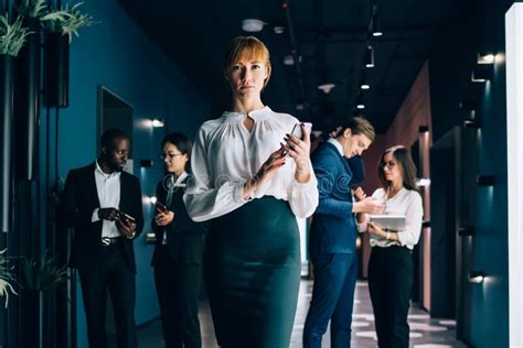 Lovely Office Worker Messaging On Phone At Workplace Stock Image