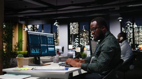 Black Male Administrator In Modern Workspace Analyzing Forecast