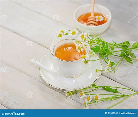 Шар заполнил с медом и ложкой цветка с чашкой чаю Стоковое Изображение изображение