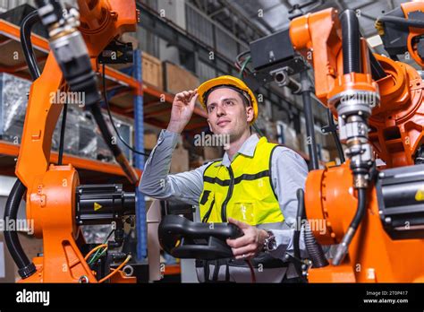 Smart Modern Engineer Male Using Modern Robot Technology Robotic Welding Arm Setup In