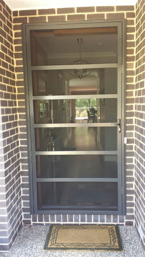 Large Strong Steel Security Door With Stainless Steel Mesh And Triple Lock System Installed On A