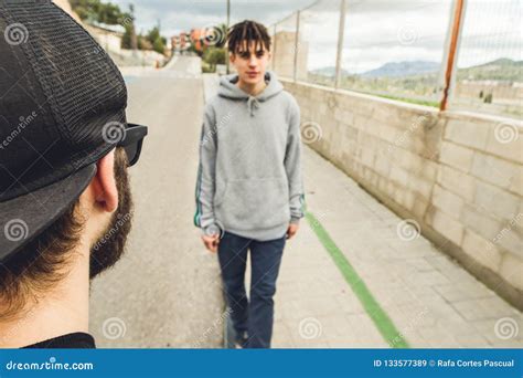 Two Guys Looking At Each Other Two Friends Looking At Each Other In The Street Stock Image