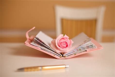 Premium Photo Pink Rose On An Open Notebook