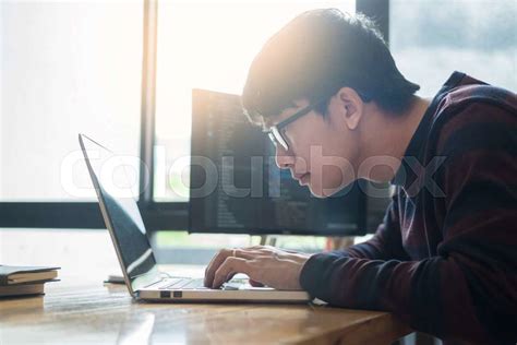 Pensive Programmer Working On On Desktop Pc Programming Code Colourbox