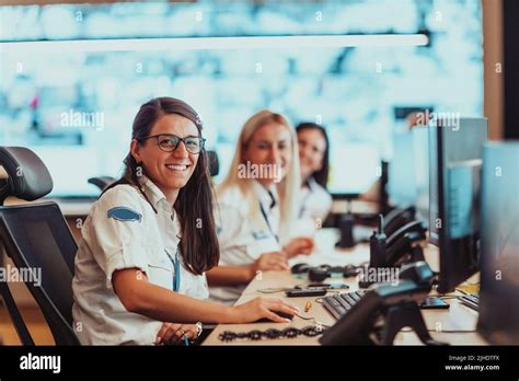 Group Of Female Security Operators Working In A Data System Control Room Technical Operators