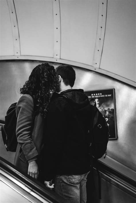 Public Transportation Grayscale Adult Coat Kissing Transportation Togetherness Banister
