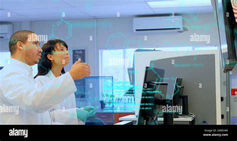 Image Of Data Processing Over Diverse Male And Female Scientists Discussing At Laboratory Stock