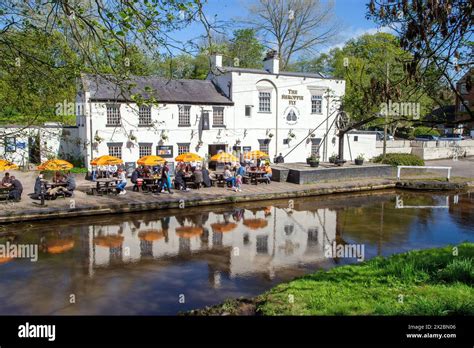 People Sitting Outside Eating And Drinking At The Canalside Pub The