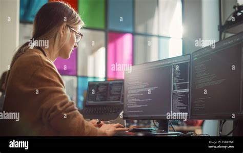 Female Software Engineer Writing Lines Of Code On Professional Multiple