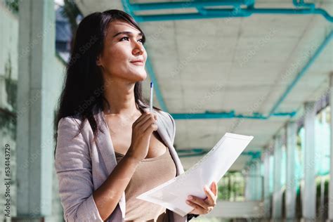 Building Inspector Thai Woman Checking Construction Site And Taking Notes Holding Pen And Paper