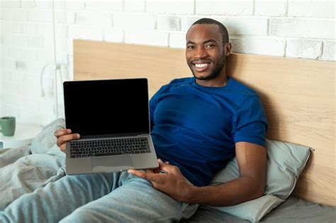 Premium Photo Black Man Showing Laptop Computer With Blank Screen At Home