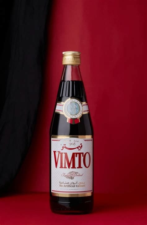 Vimto Juice Bottle On Red Table