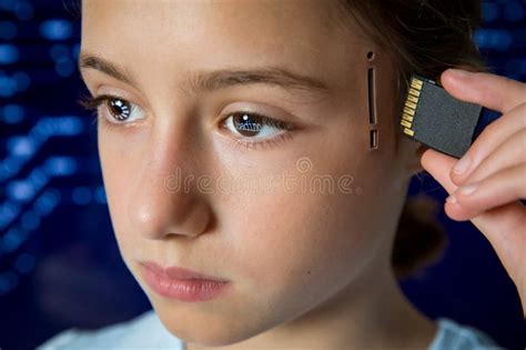 Teenage Girl Inserting SD Memory Card Into Slot In Her Head Stock