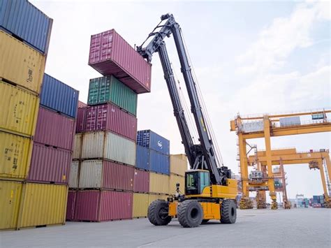 A Reach Stacker Lifting And Stacking Shipping Containers At A Container Terminal Premium Ai