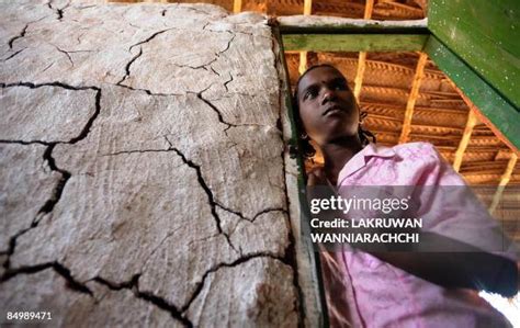 A Sri Lankan Tamil Girl Looks Out Of Her Temporary Wattle And Daub