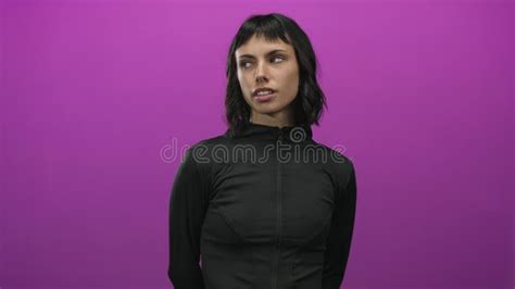 Young Hispanic Woman In Black Athletic Jacket Gazes Upward With Arms