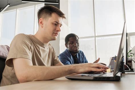 Two Programmers Working In The Office Of A Software Development Company