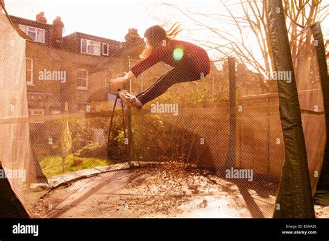 Girl Mid Air In Trampoline Stock Photo Alamy