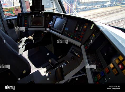 A Modern Train Control Panel With Illuminated Buttons In A Dimly Lit Train Control Room Stock
