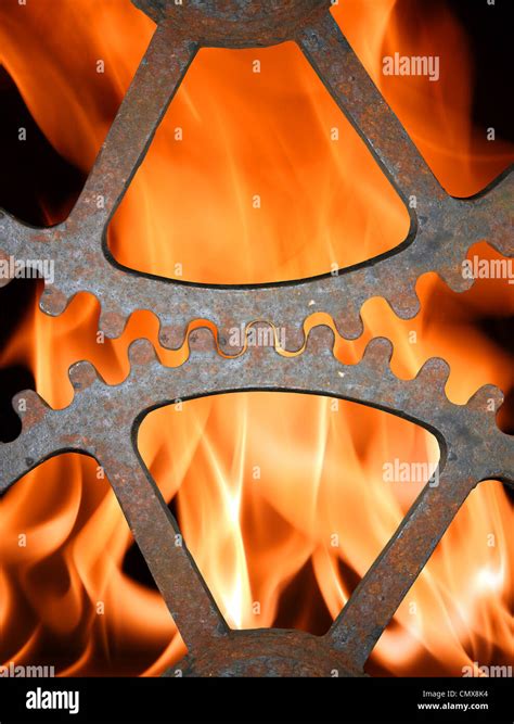 Rusty Cogs Against A Background Of Flames Stock Photo Alamy