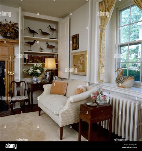 Small White Sofa In Front Of Radiator In Townhouse Sitting Room With