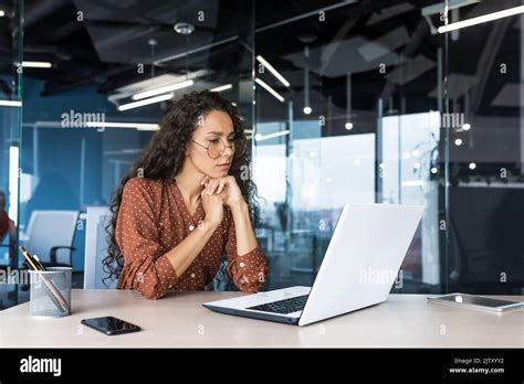 Pensive And Focused Female Programmer Web Developer Working In Modern