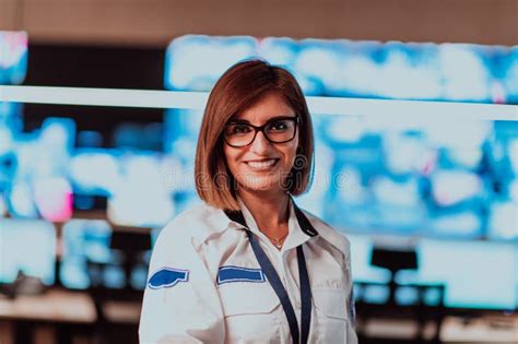 Female Security Operator Working In A Data System Control Room Offices
