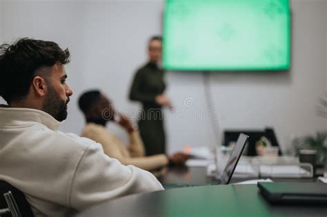 Successful Corporate Team Collaborating And Analyzing Statistics In A Boardroom Meeting Stock