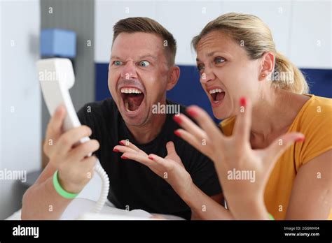 Man And Woman Shouting Into Telephone Receiver In Hotel Room Stock Photo Alamy