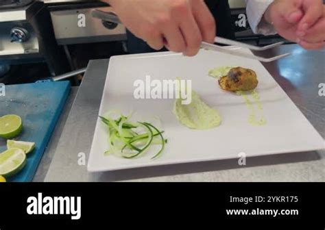 Plating Of A Raw And Cooked Fish Based Appetizer In A Luxury Italian