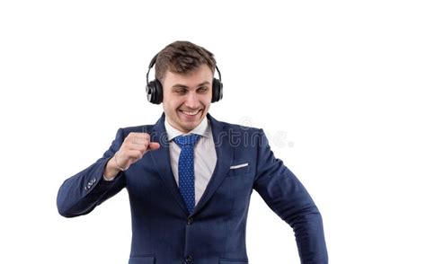 танцует красивый мужчина в деловом костюме с наушниками концепция свободы в бизнесе в студии