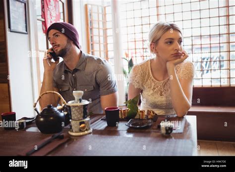 Man Ignoring Woman While Talking On Phone Stock Photo Alamy
