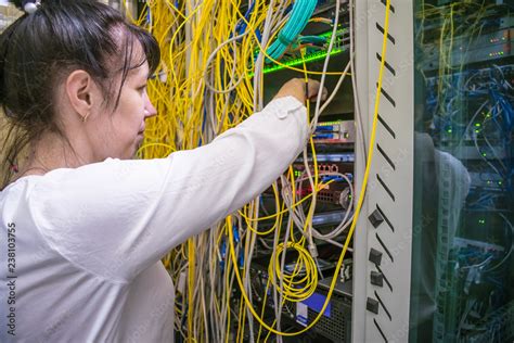 The Woman Works In The Server Room Of The Data Center The Girl Switches Fiber Optic Internet