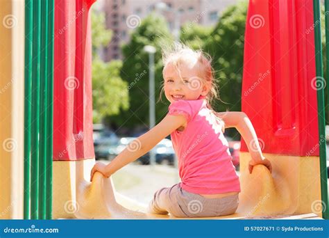 Счастливая маленькая девочка на скольжении на спортивной площадке детей Стоковое Изображение