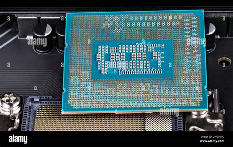 Closeup Of Processor Installation To Computer Mainboard Socket Green