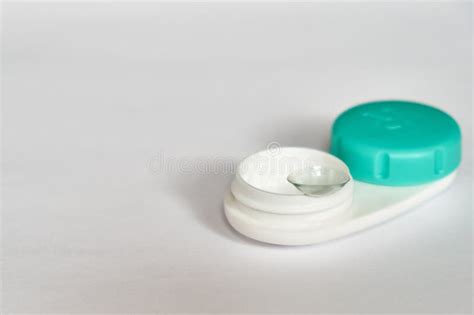 On The Edge Of The Container Lies A Contact Lens For The Eyes The Topic Of Medicine And Health