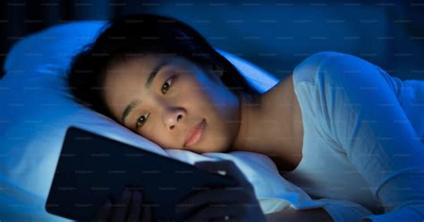 Asian Women Are Using The Tablet On The Bed Before She Sleeping At