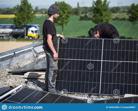 Male Team Engineers Installing Stand Alone Solar Photovoltaic Panel System Electricians