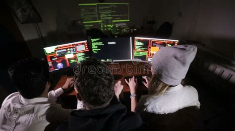 Team Of Multiethnic It Professionals Working With Computers In Dark