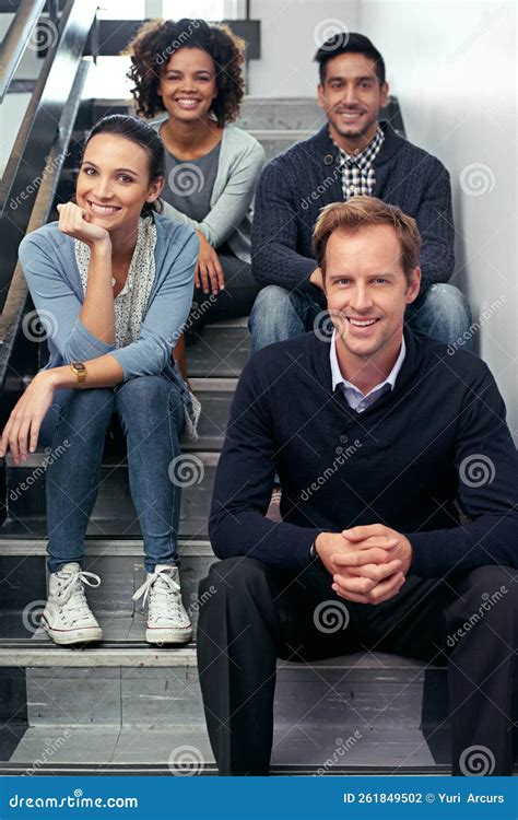 Taking A Team Timeout Portrait Of A Group Of Office Coworkers Sitting In A Stairwell Stock