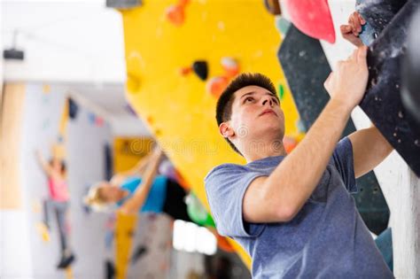 Alpinist Practicing Indoor Rock Climbing On Artificial Boulder Without Safety Belts Stock Image