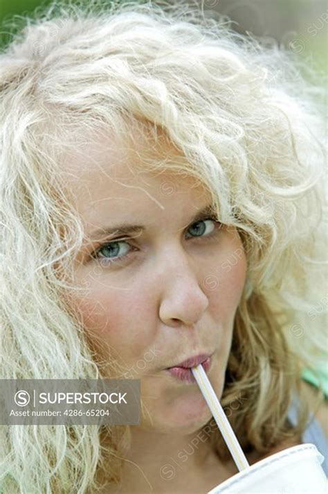 Woman Sticking Mug Coke Coke Straw Superstock