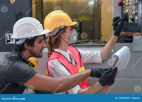 Industrial Or Factory Engineering Worker And Supervisor Setting Up Computerized Control Panel Of