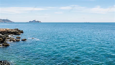 Coastal Tranquility Background Shore Rocky Sea Background Image And